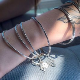 Double Silver Bangle joined by a Silver Hamsa